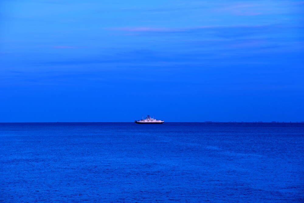 By boat the blue horizon overseas - Photographic print for sale