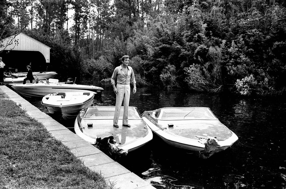 Roger Moore takes a break on the set of the James Bond film ...